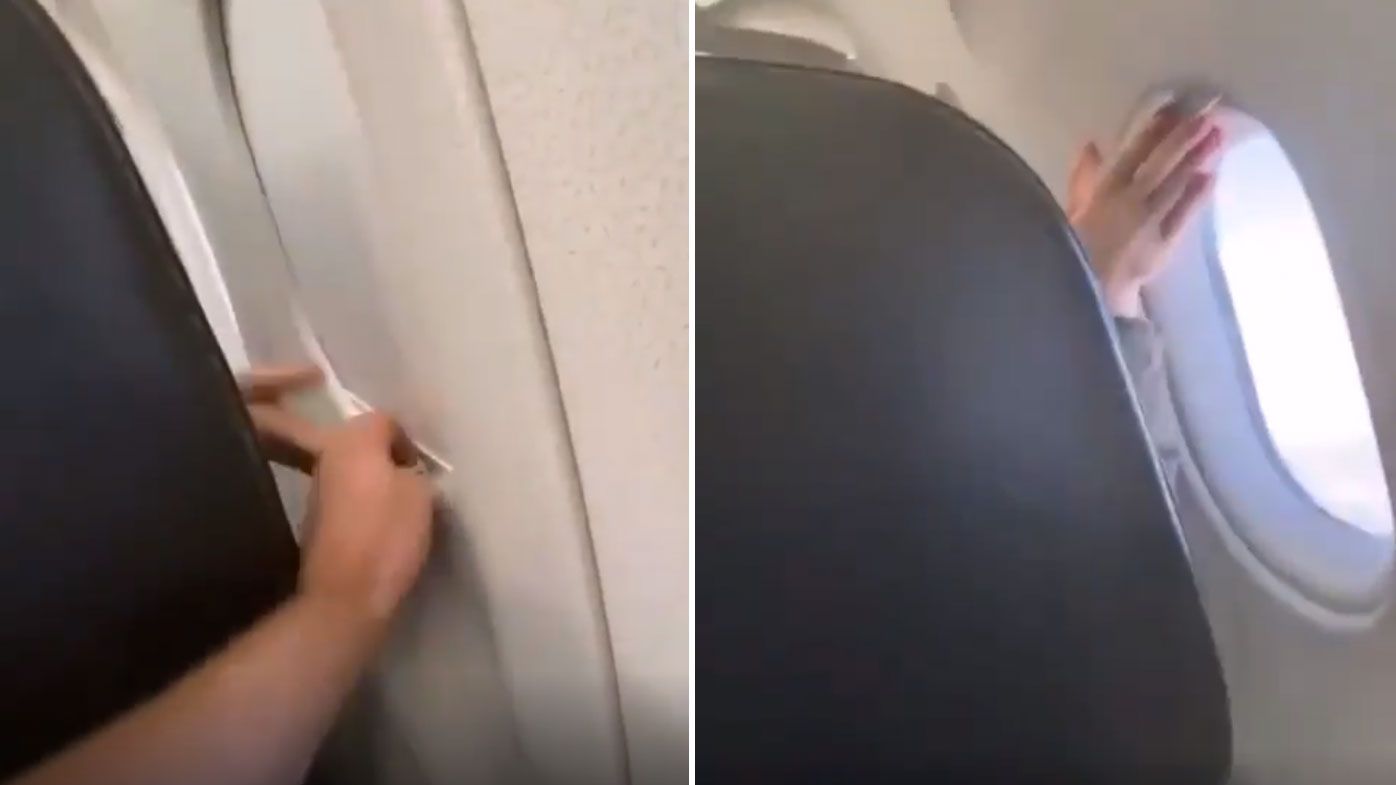 Watch two passengers fight over plane window shade - 9Travel
